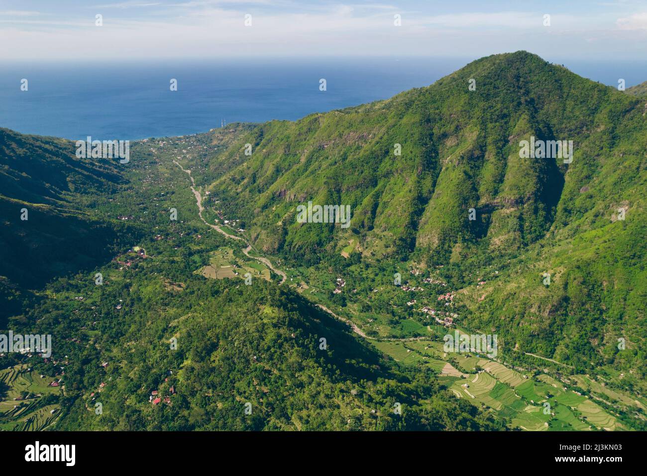 Overview of Mount Abang, with a blue, cloudy sky and lush vegetation ...