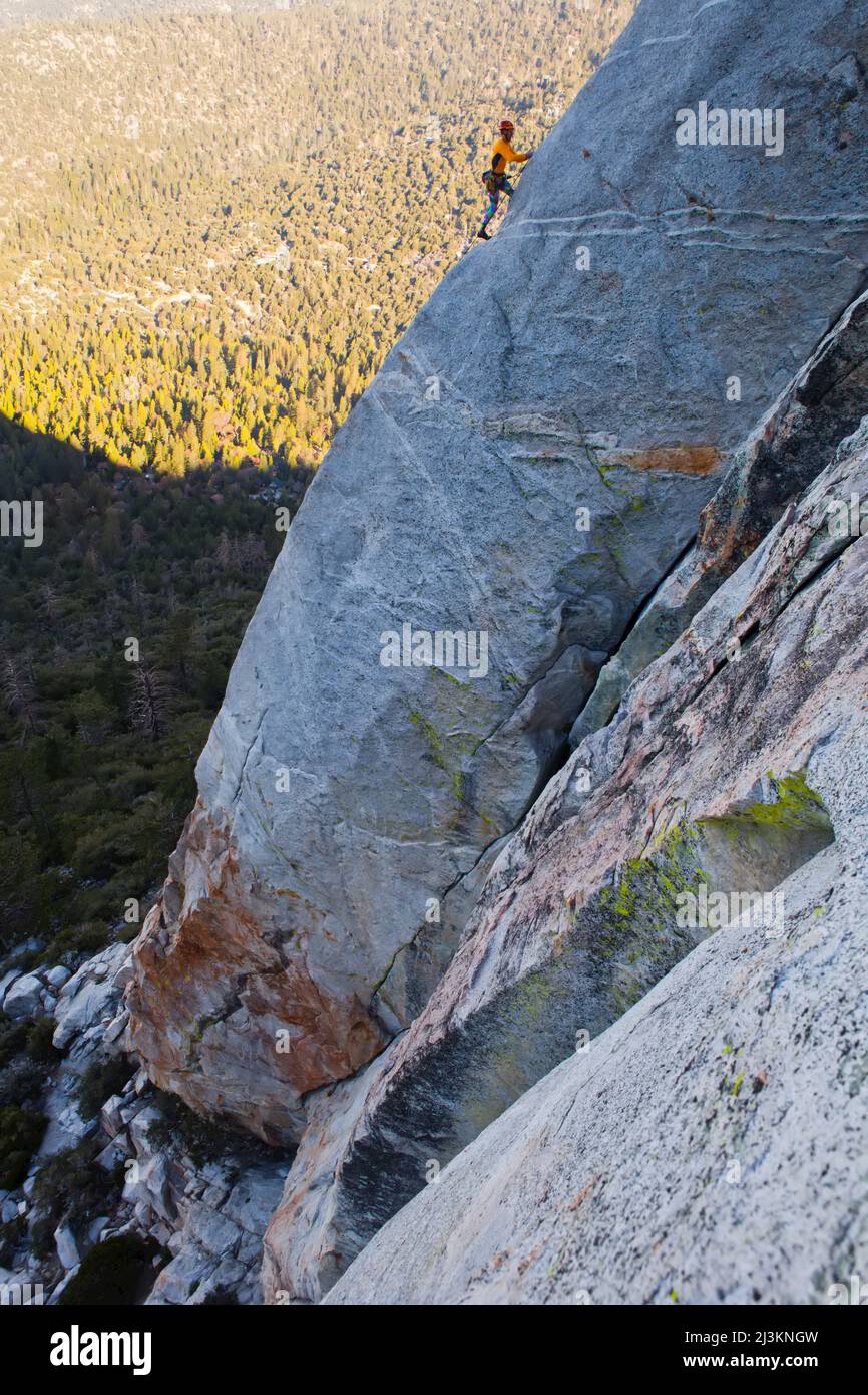 A man climbs above the scary and difficult route 'The Edge' on Tahquitz ...