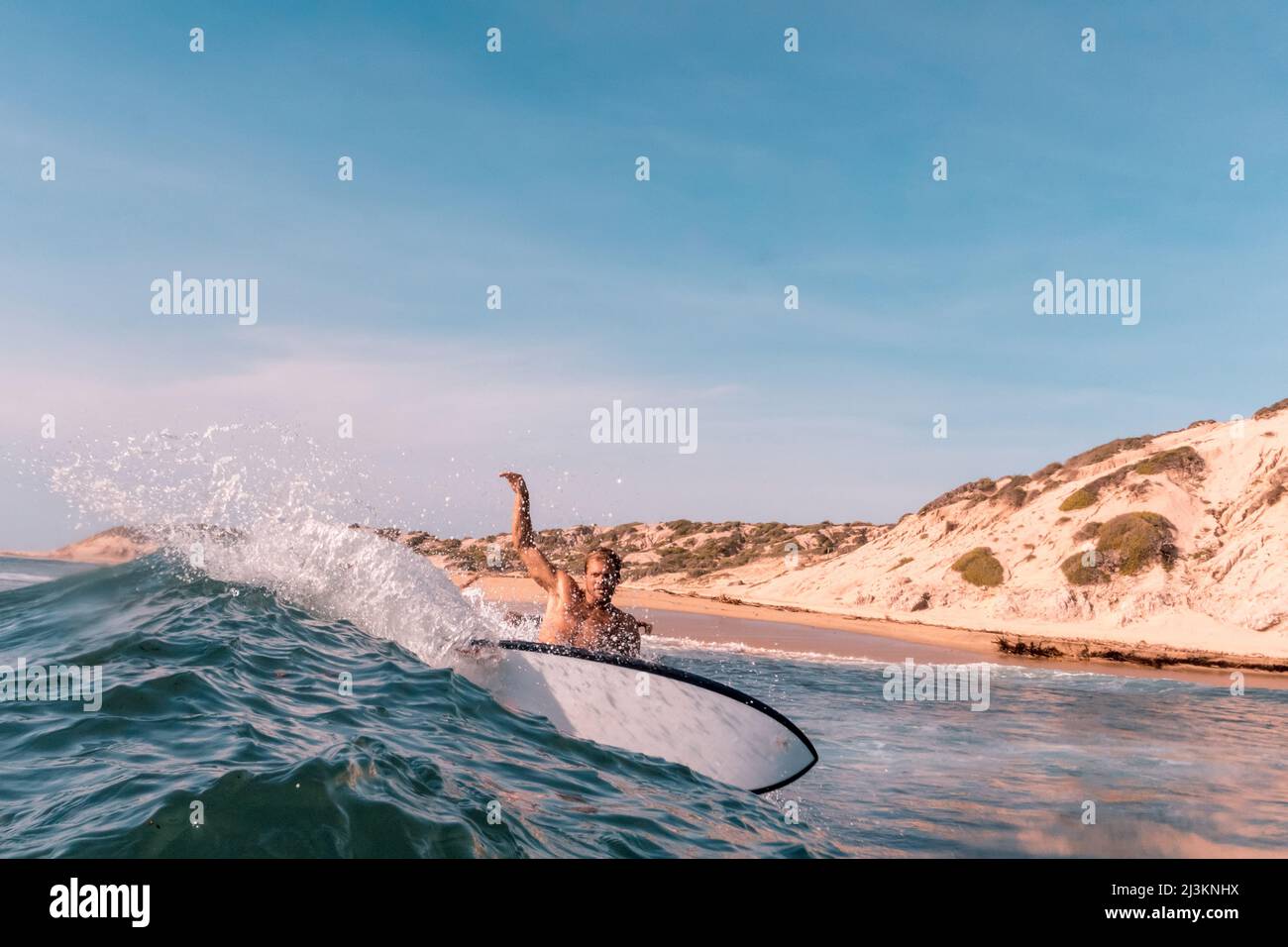 Portrait of a surfer riding the waves on the East Cape of the Baja ...