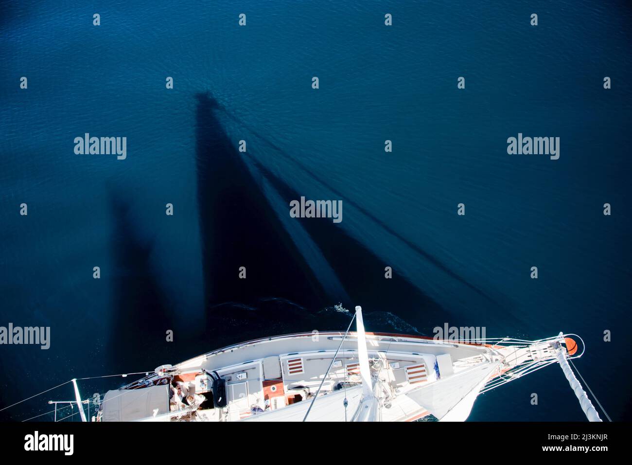 The shadow of a sailboat cast across the ocean Stock Photo - Alamy