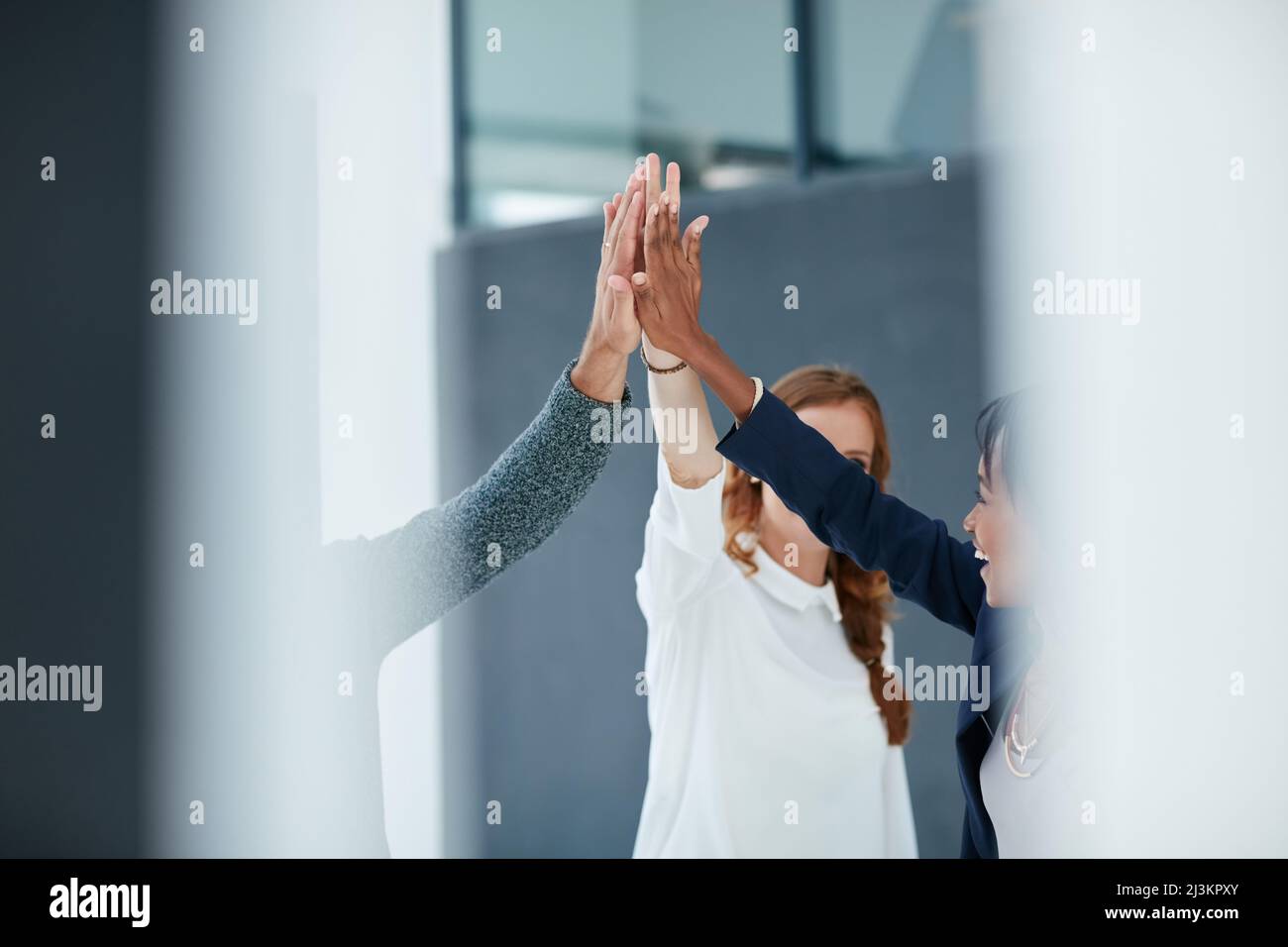 Celebrating a job well done. Cropped shot of colleagues high fiving together in an office Stock ...
