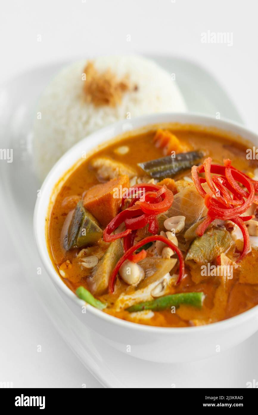 traditional spicy thai chicken red curry with steamed rice on white ...