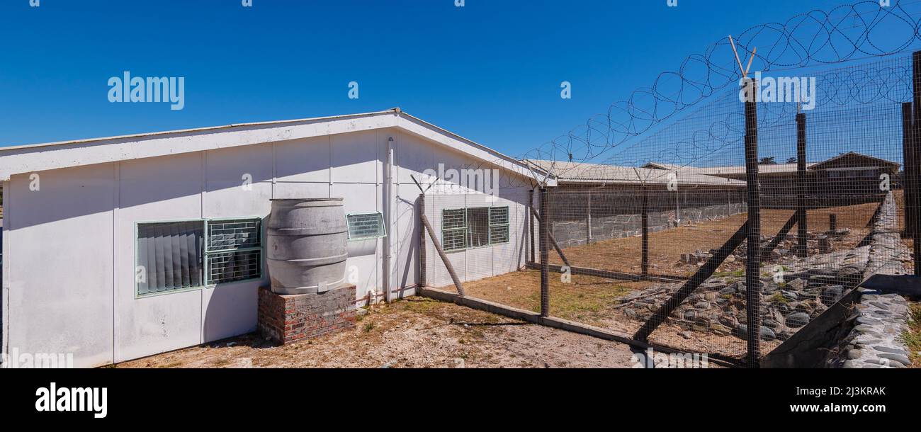 Barbed wire fence and buildings at Robben Island Prison; Robben Island ...