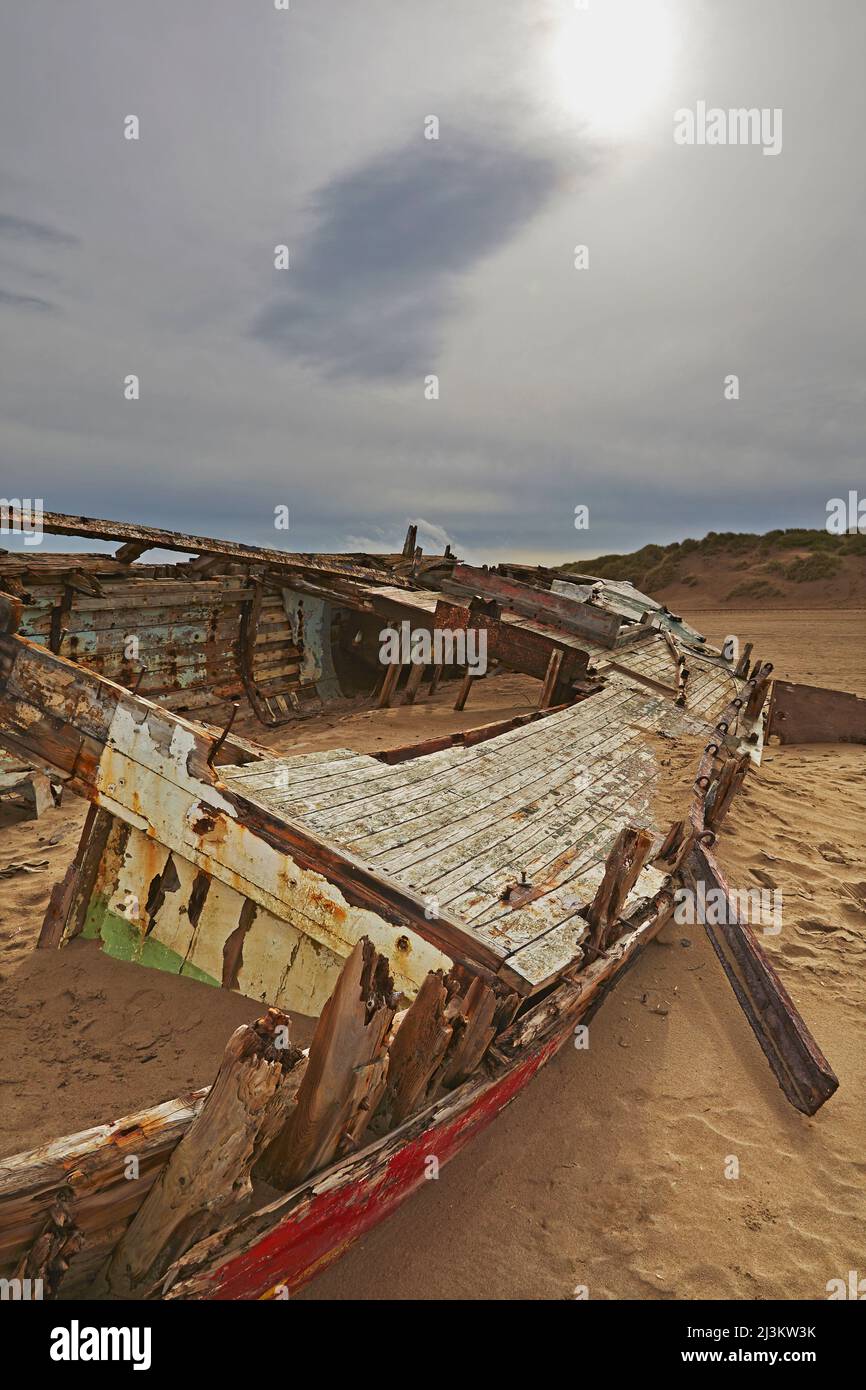 Weathered shipwreck lying in sand dunes at Crow Point, at the mouth of ...