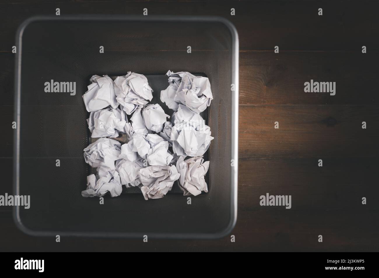 crumpled in rubbish bin. Waste paper in office garbage bin. Junk ...