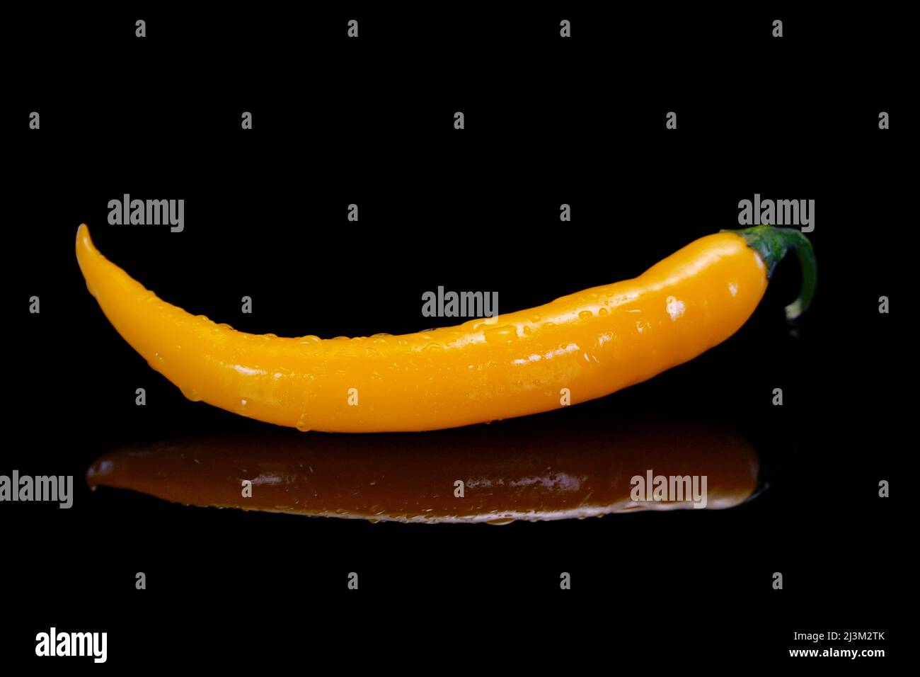 Chilli peppers on a black background. Fresh yellow hot chilli pepper ...