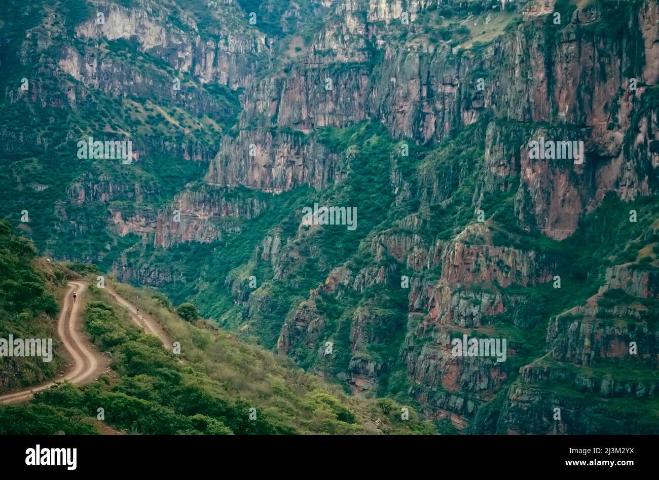 Tracks wind down a hillside, rocky outcroppings on opposite mountain ...
