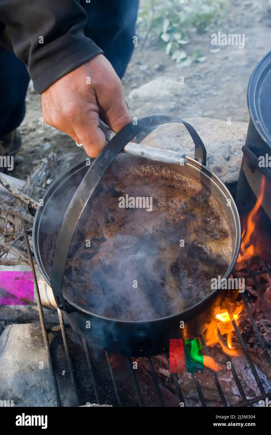 Cooking camp coffee over a wood fire.; Winisk River, Ontario, Canada ...