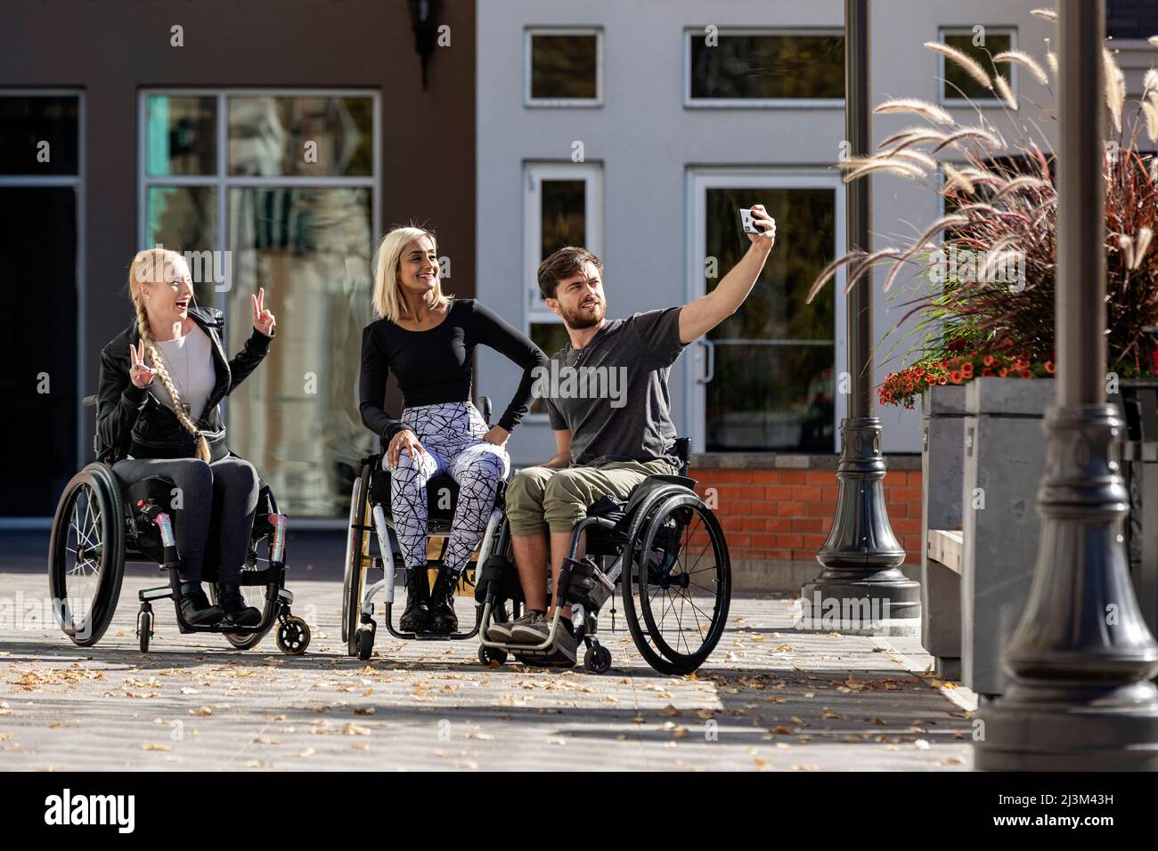 Three young paraplegic friends spending time together shopping and ...