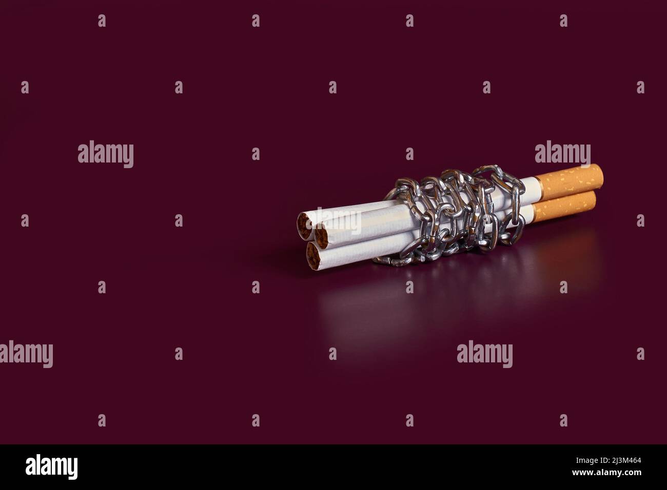 Nicotine addiction. Three cigarettes rewound by a chain Stock Photo - Alamy