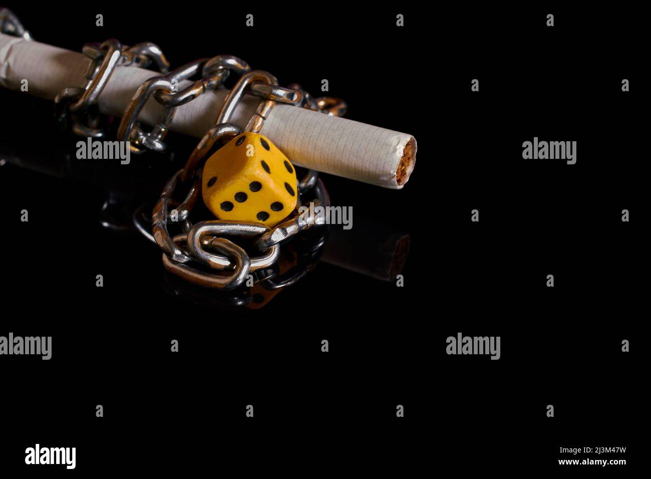 Nicotine and gambling addiction. Cigarette, rewound by a chain and a ...