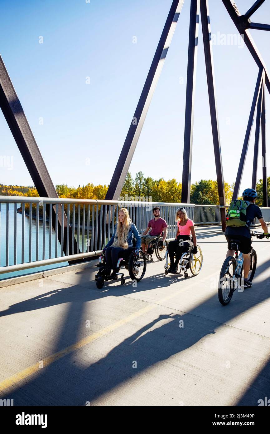 Three young paraplegic friends spending time together moving across a ...