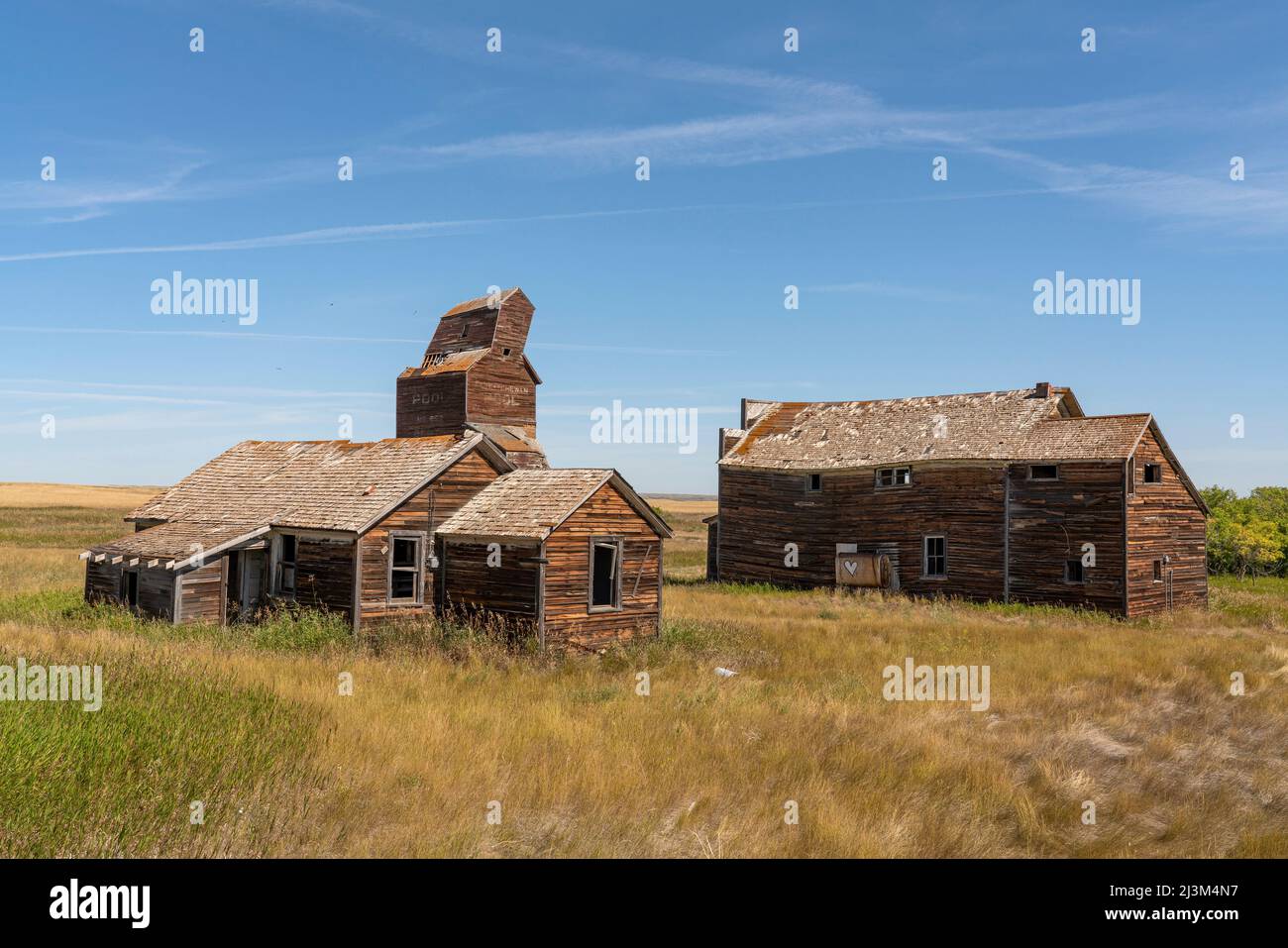 Old abandoned buildings and grain elevator in rural Saskatchewan; Bents ... Old abandoned buildings and grain elevator in rural Saskatchewan; Bents ...