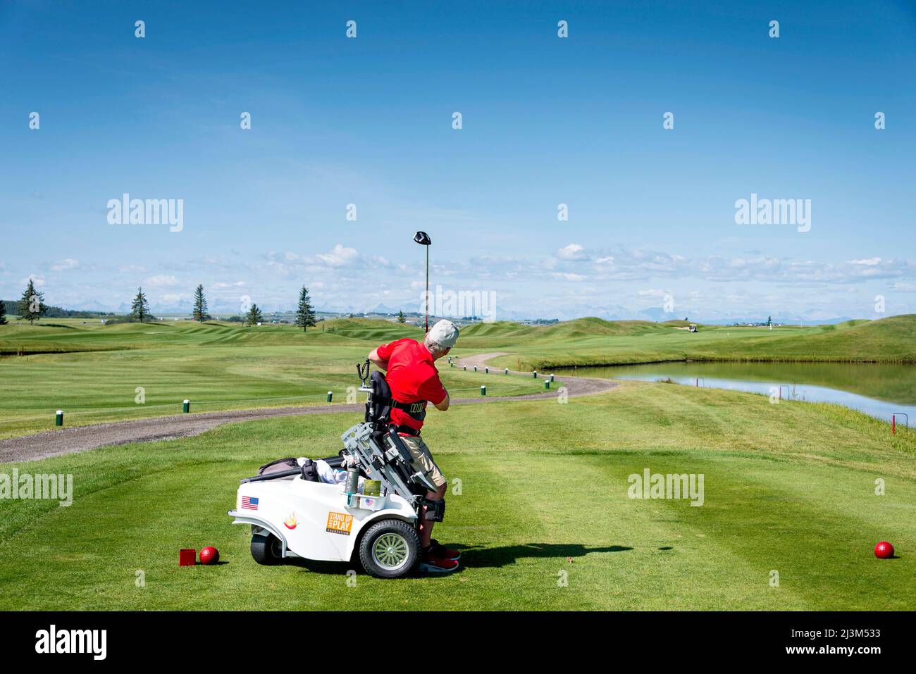 Disabled golfer using a specialized golf assistance motorized hydraulic ...