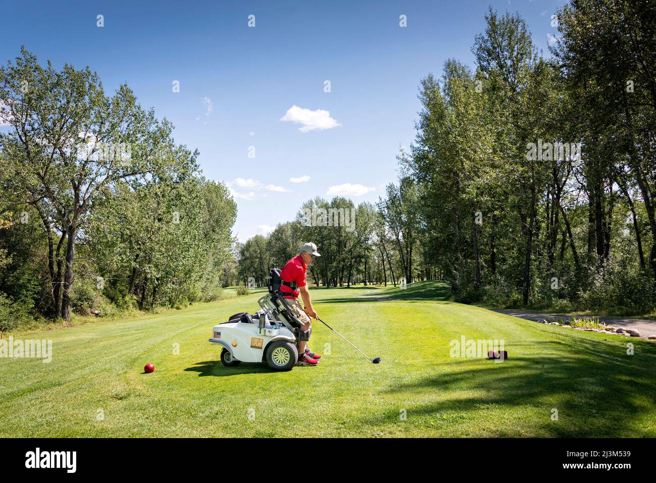 Disabled golfer using a specialized golf assistance motorized hydraulic ...