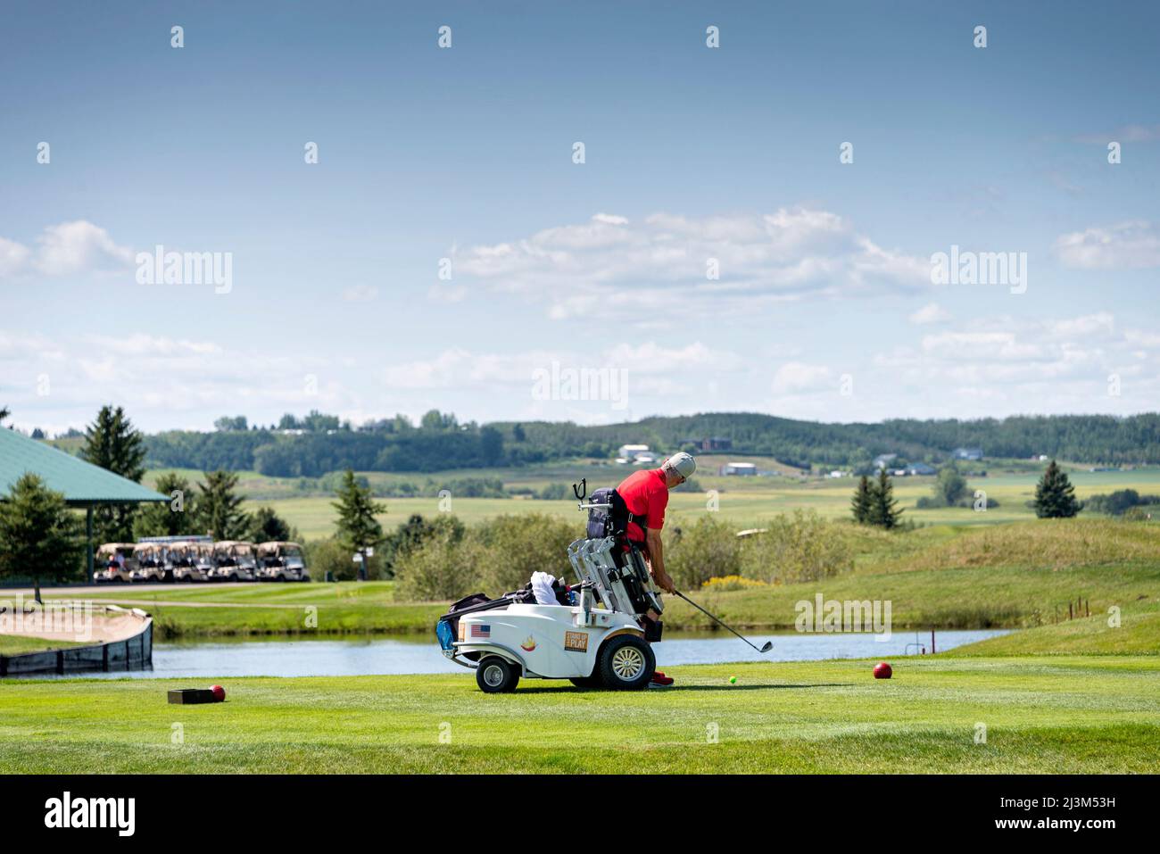 Disabled golfer using a specialized golf assistance motorized hydraulic ...