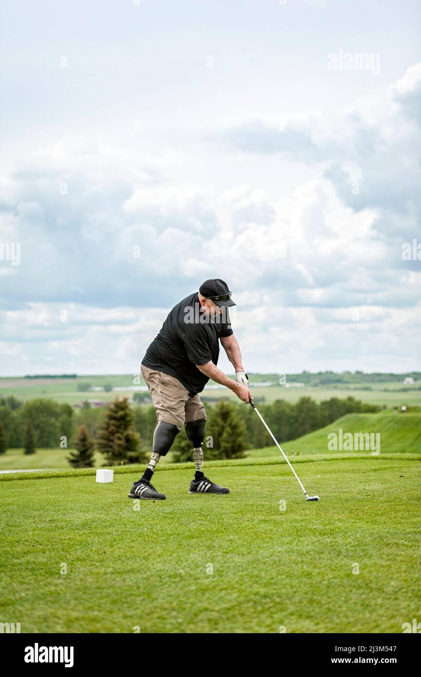 Double amputee with leg prosthetics on the golf course; Okotoks ...