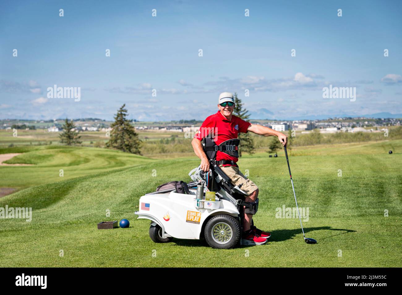 Disabled golfer using a specialized golf assistance motorized hydraulic ...