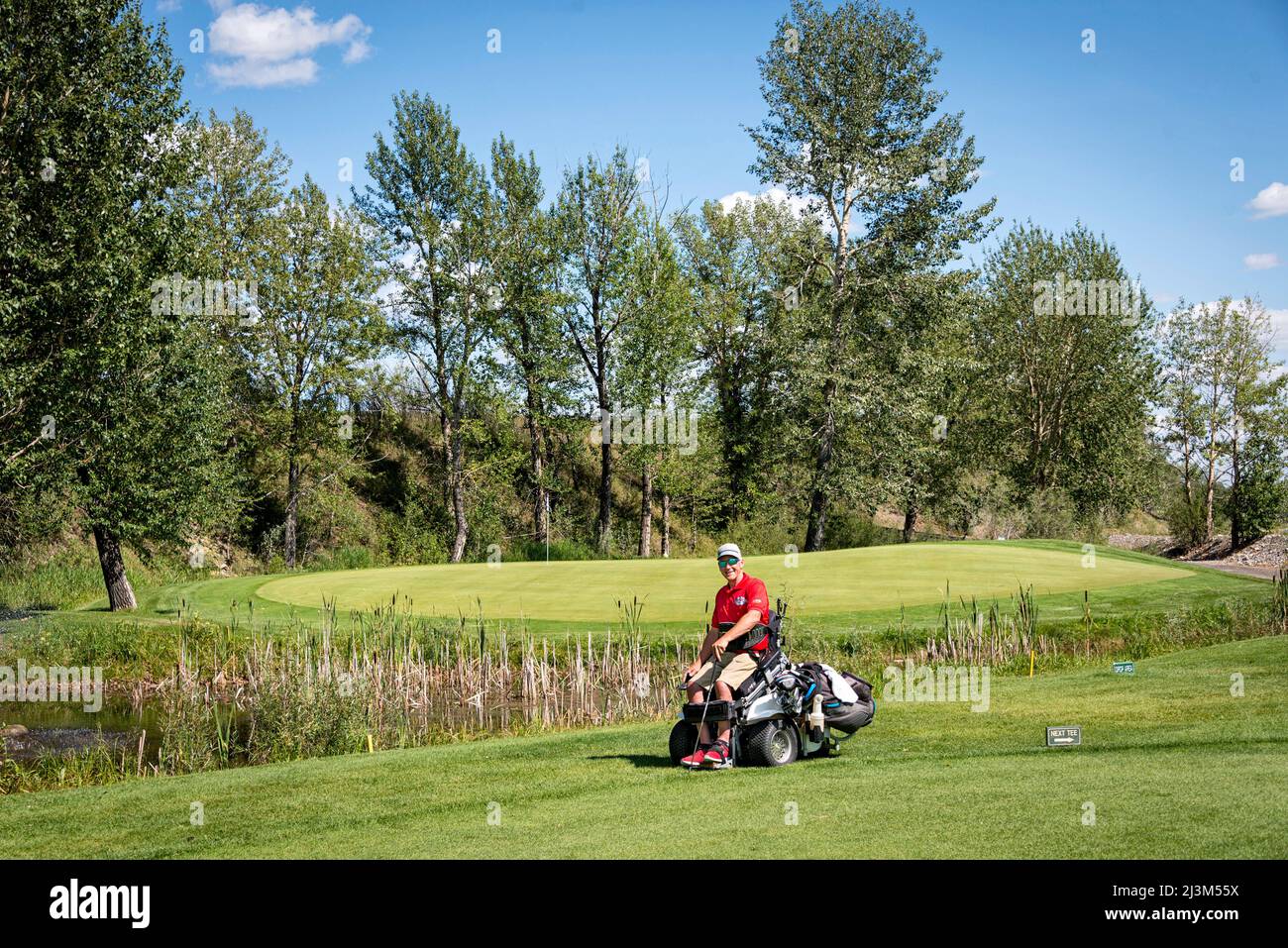 Disabled golfer using a specialized golf assistance motorized hydraulic ...