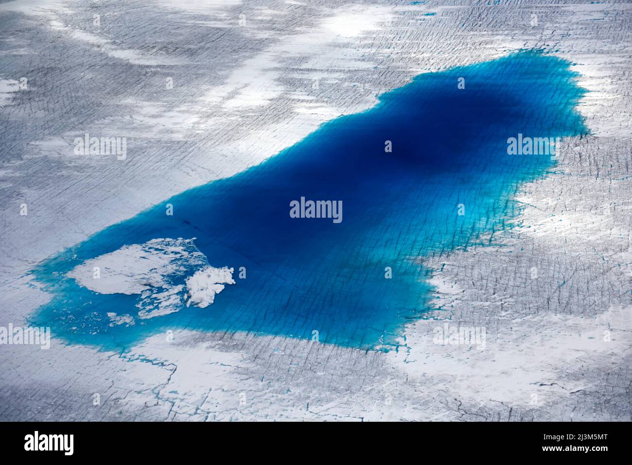 A large pool of water remains on the surface of an ice cap.; Greenland ...
