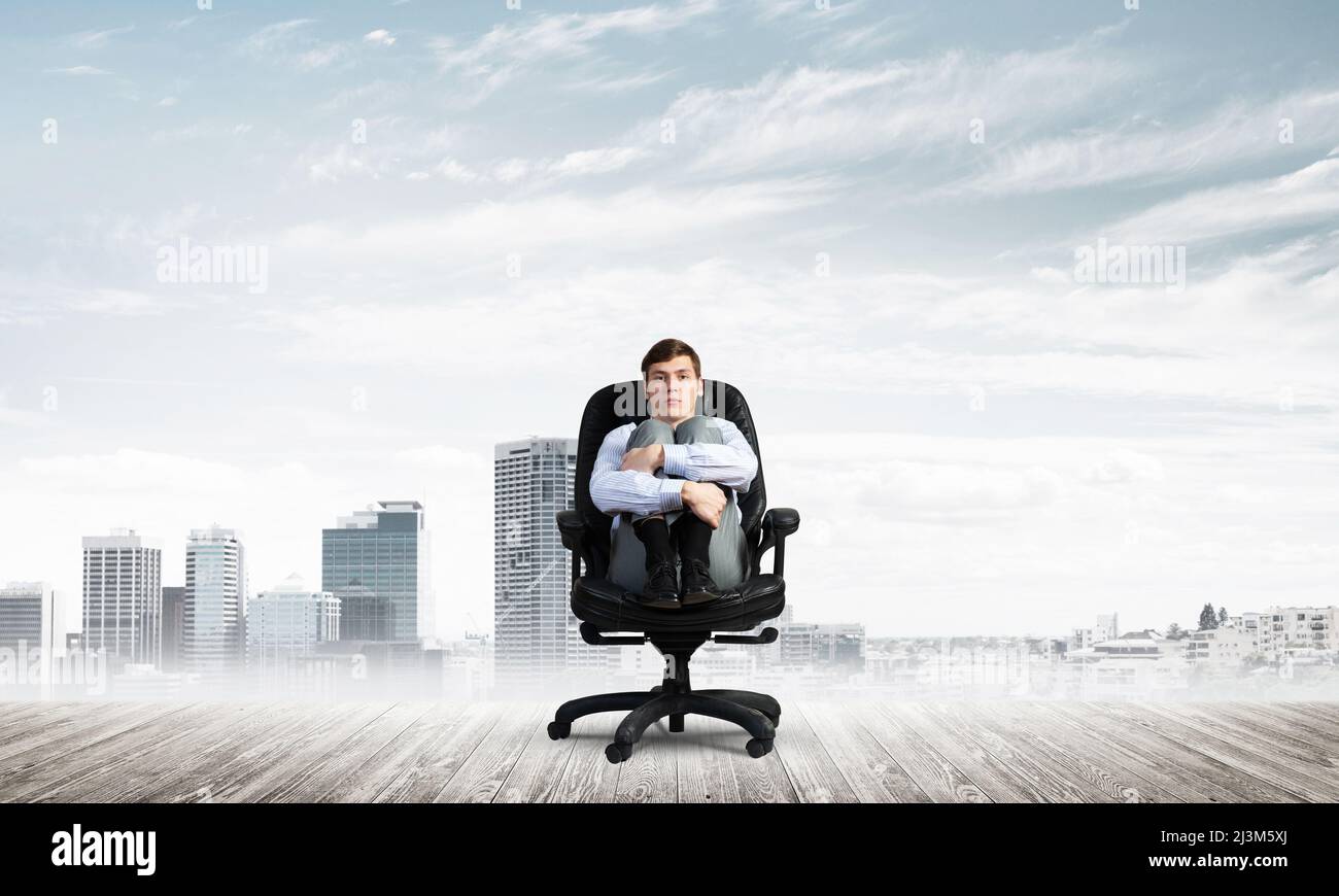 scared businessman on a chair Stock Photo - Alamy