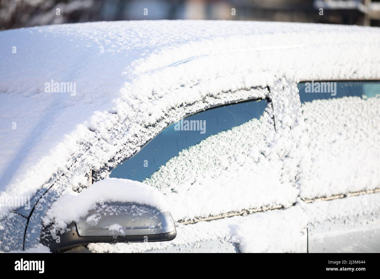 Car covered with a thin layer of fresh white snow. Side view Stock ...