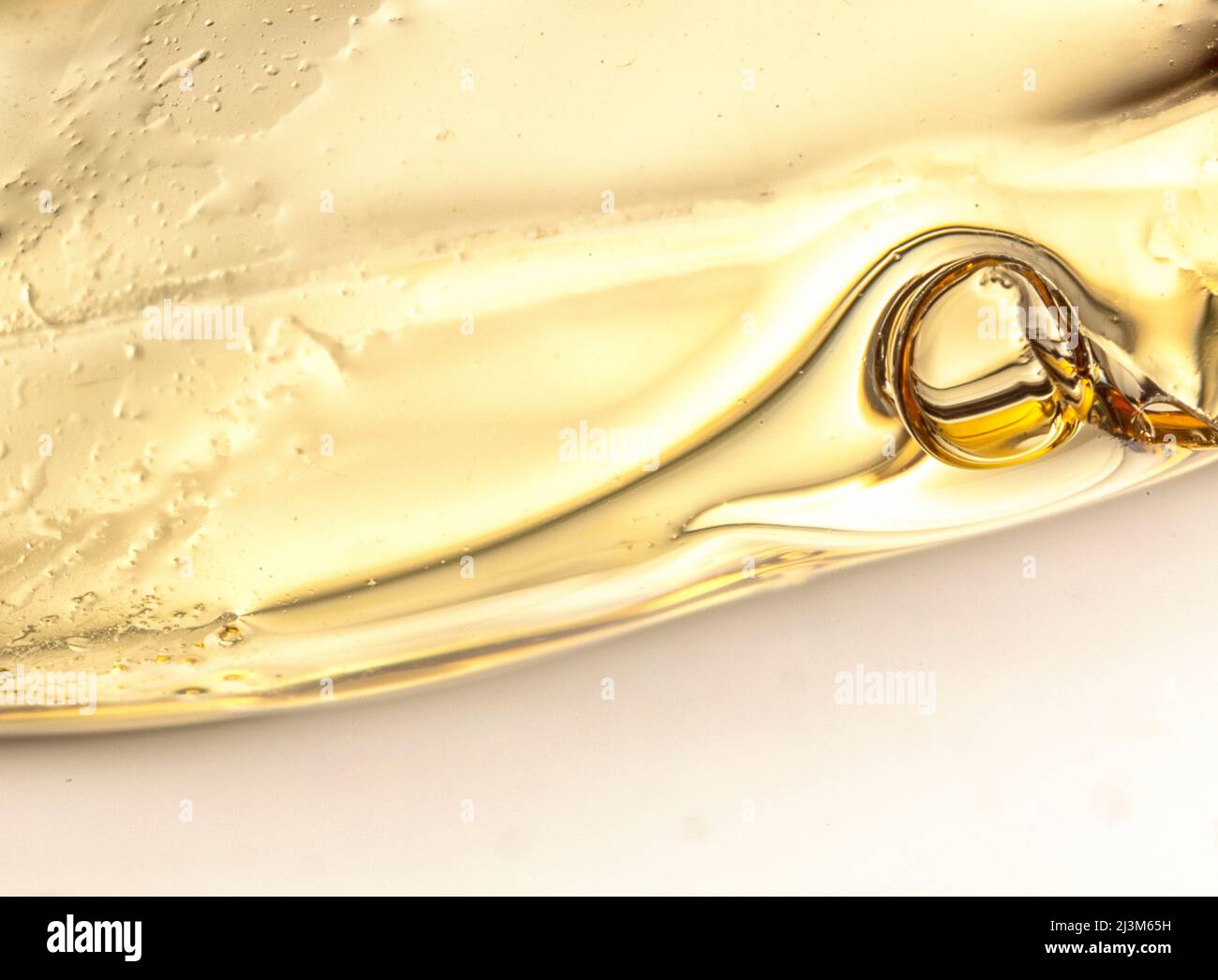 Macro photograph of burst Omega 3 capsule against a plain background ...