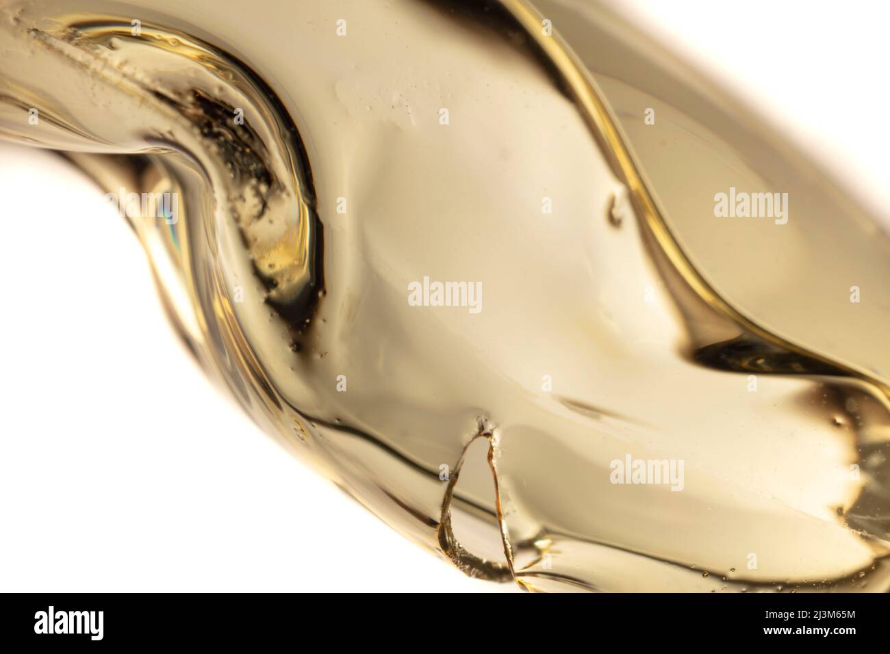 Macro photograph of burst Omega 3 capsule against a plain background ...