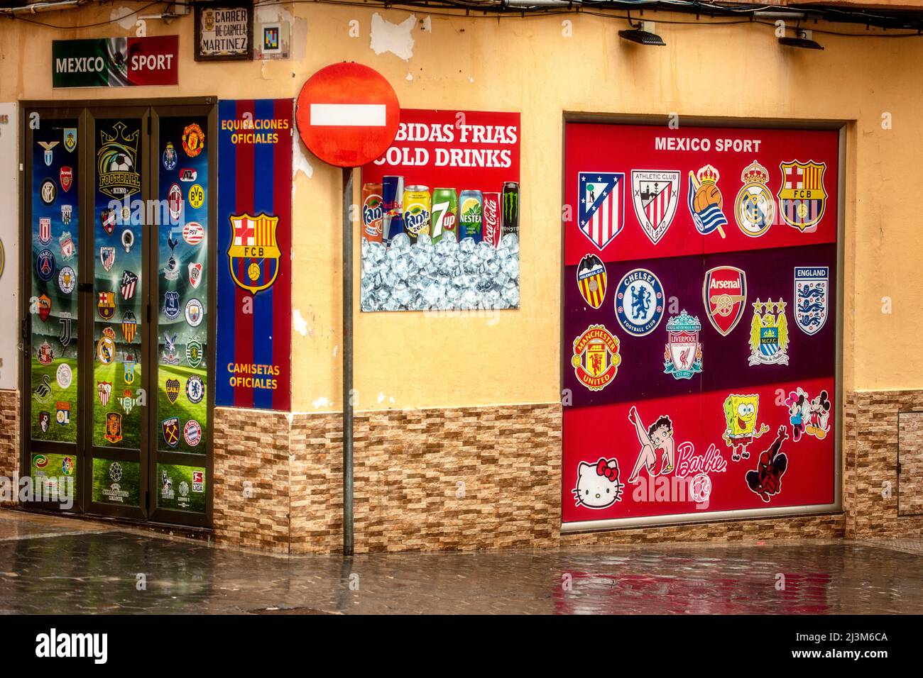 A wet day in the Old Town Benidorm with colourful football colours ...