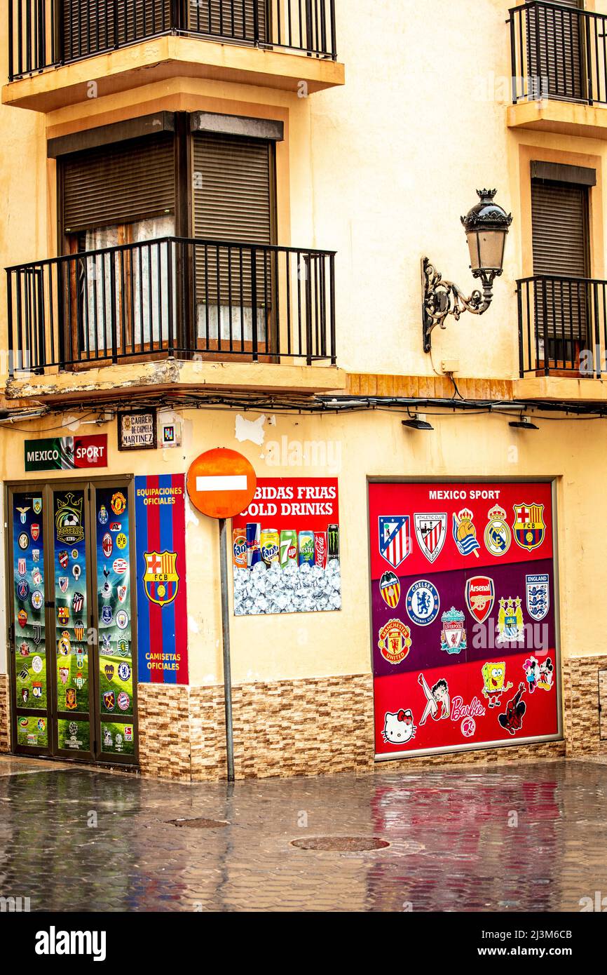 A wet day in the Old Town Benidorm with colourful football colours ...