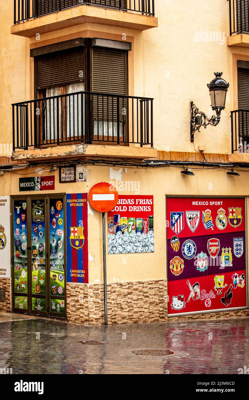 A wet day in the Old Town Benidorm with colourful football colours ...
