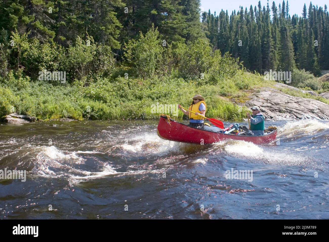 Canoeists paddle through a bouncy wave train.; Winisk River, Ontario ...