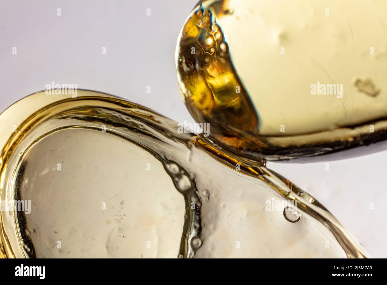 Macro still-life showing abstract patterns in Omega-3 oil capsule ...