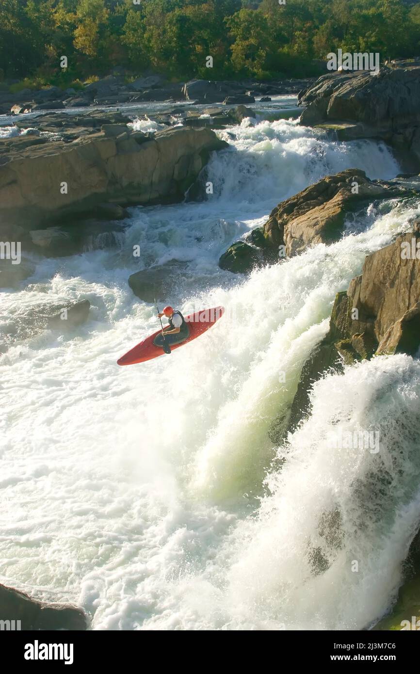 A whitewater kayaker drops off a waterfall at Great Falls.; Great Falls ...