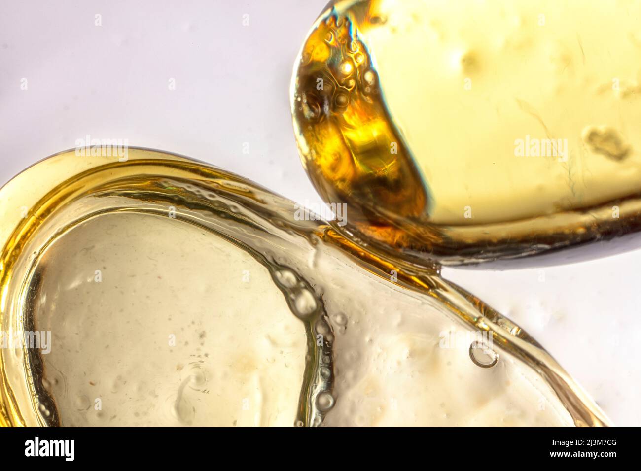 Macro still-life showing abstract patterns in Omega-3 oil capsule ...