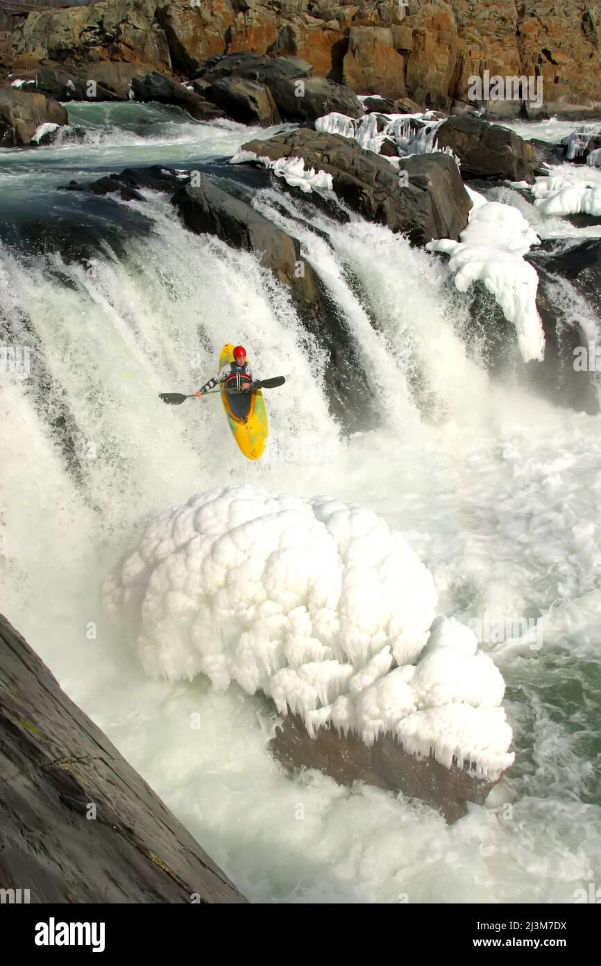 Kayaker over frozen falls in winter.; Great Falls, Virginia Stock Photo ...