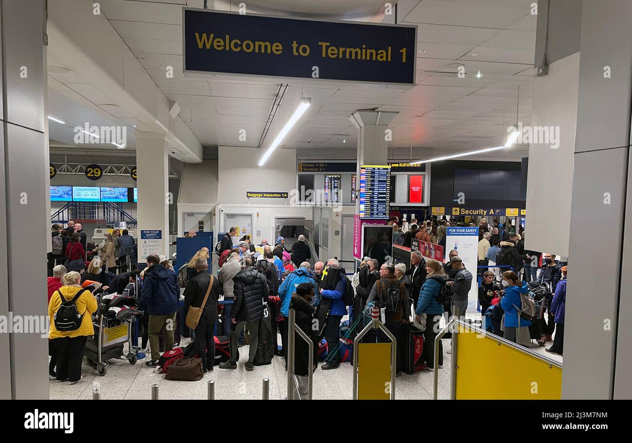 Passengers queue inside the departures area of Terminal 1 at Manchester ...