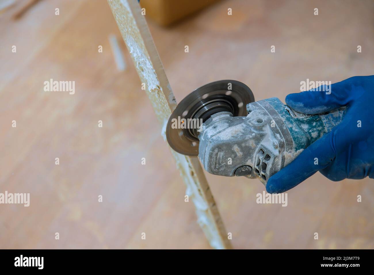 Master builder cuts a tile with machine circular saw Stock Photo - Alamy