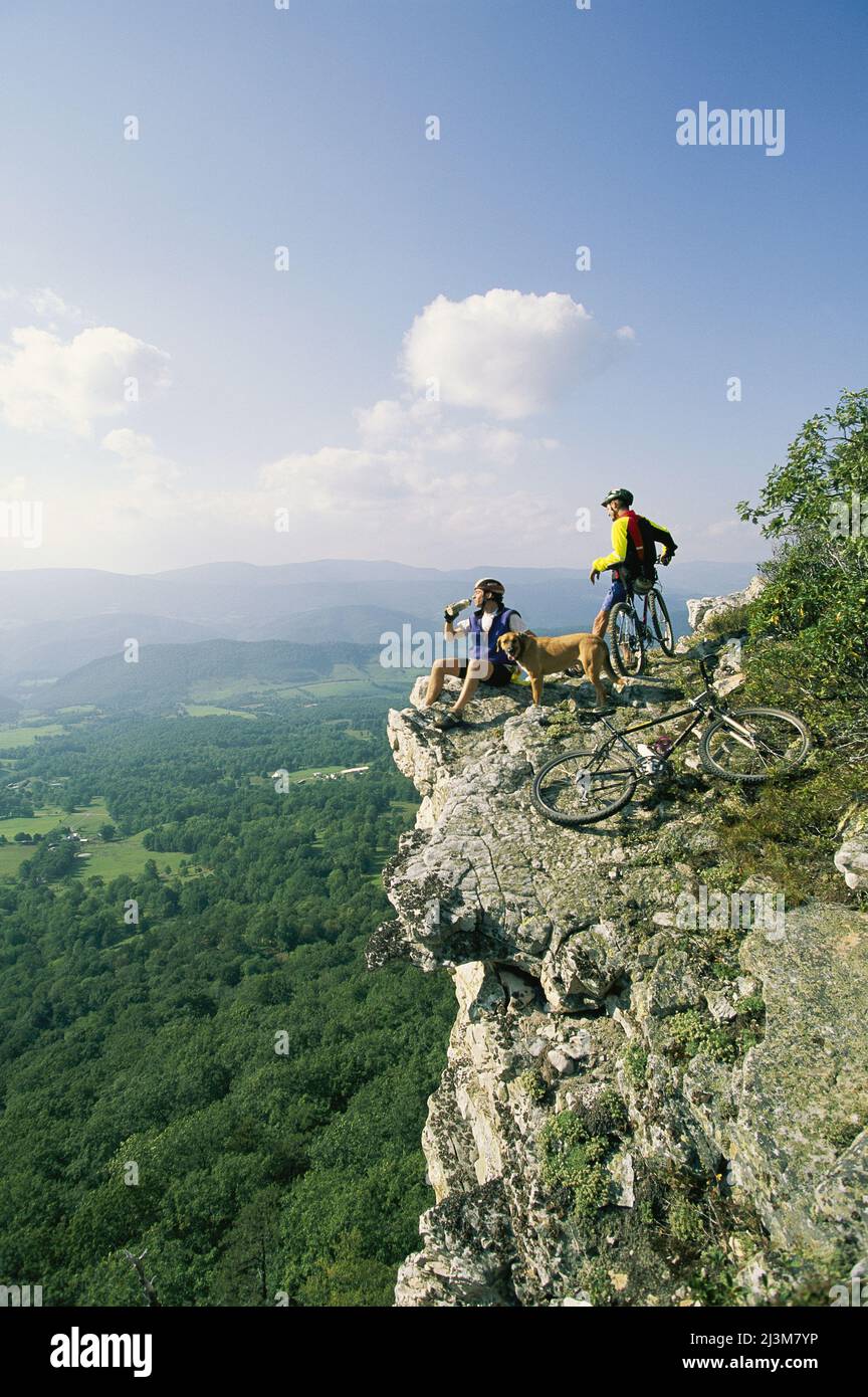 Cyclists relax on a rock outcropping overlooking Germany Valley ...