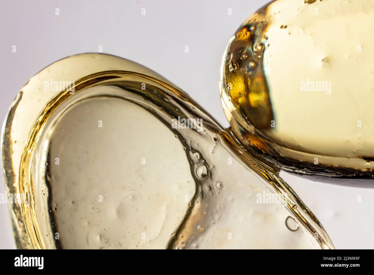 Macro still-life showing abstract patterns in Omega-3 oil capsule ...