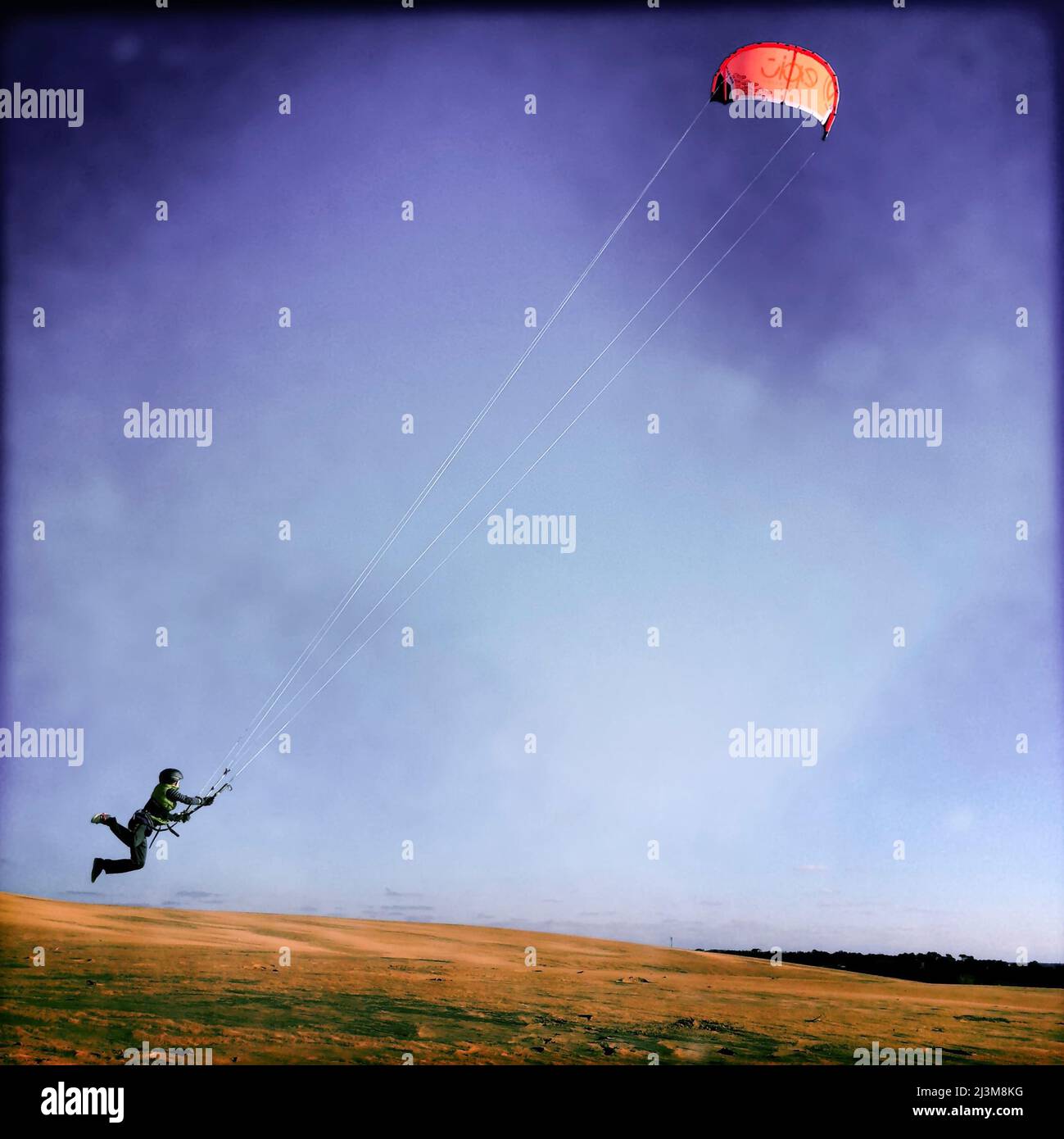 A 12 year old boy takes flight while sand kiting on the big dune at ...