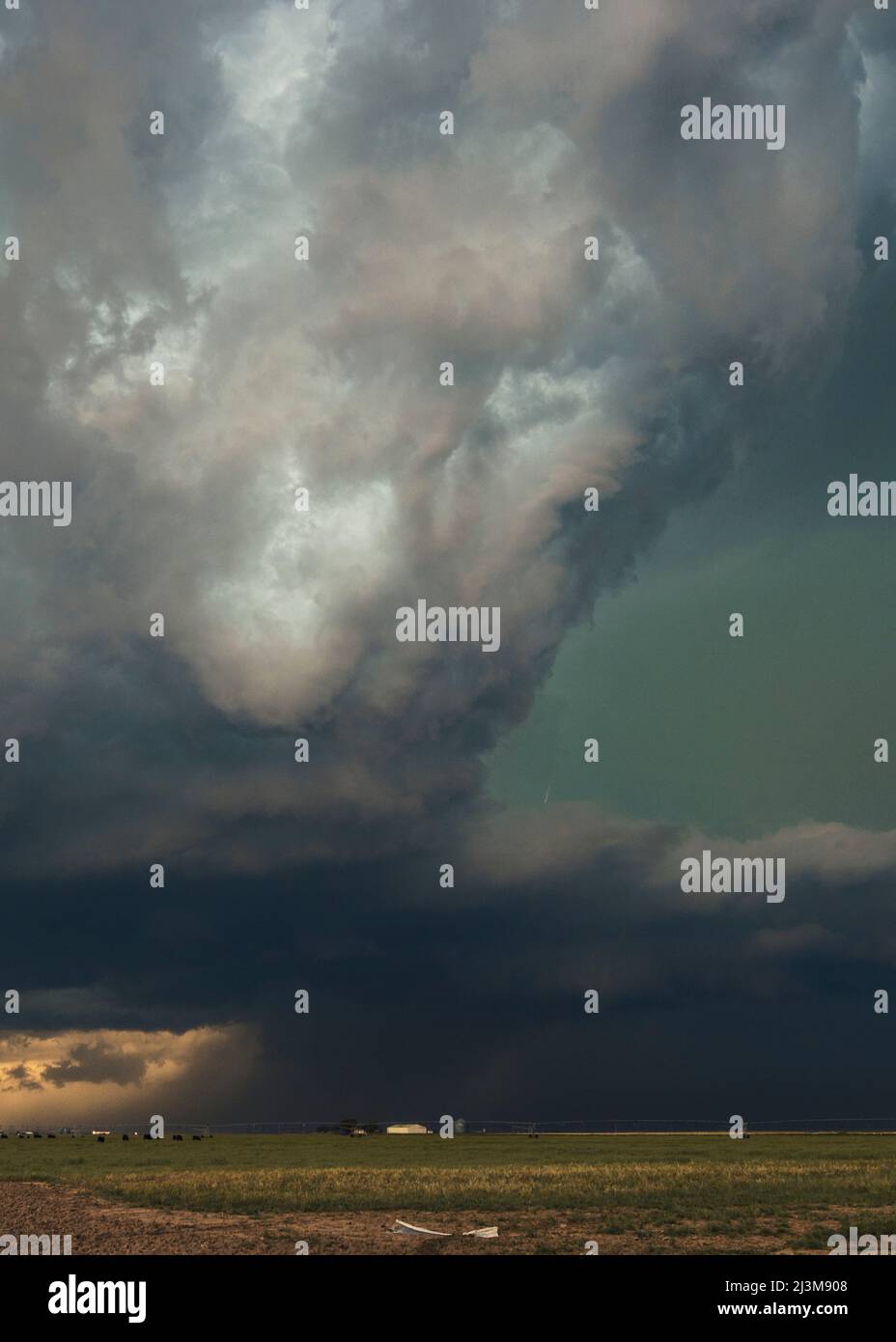 The sky turns green as an enormous supercell updraft towers over ...