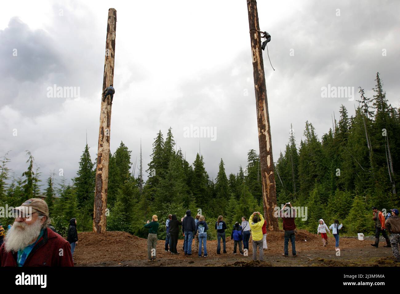 Loggers compete climbing a 65-foot pole during a logging show that ...