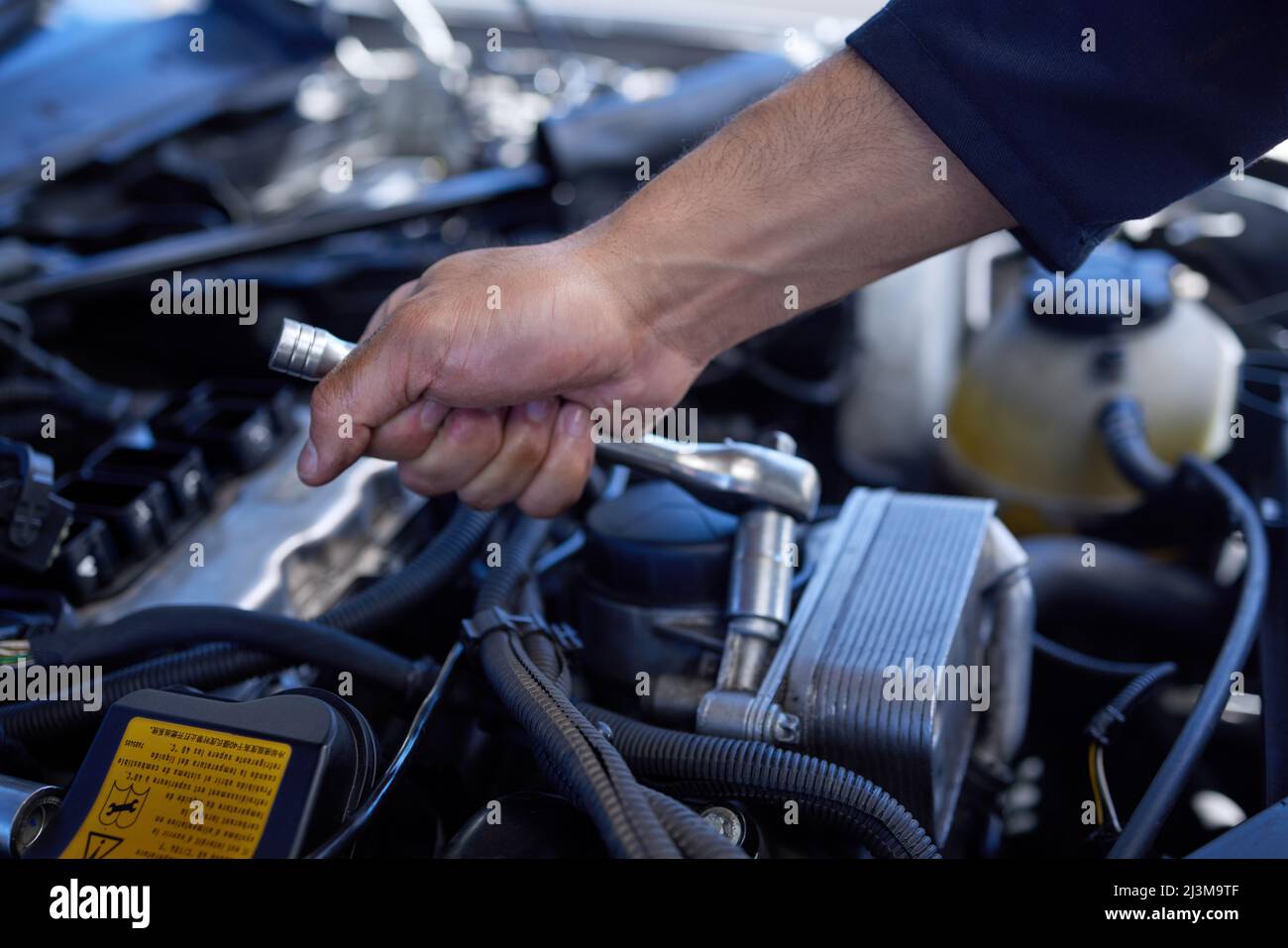 Safety first. High angle shot of an unrecognizable male mechanic ...