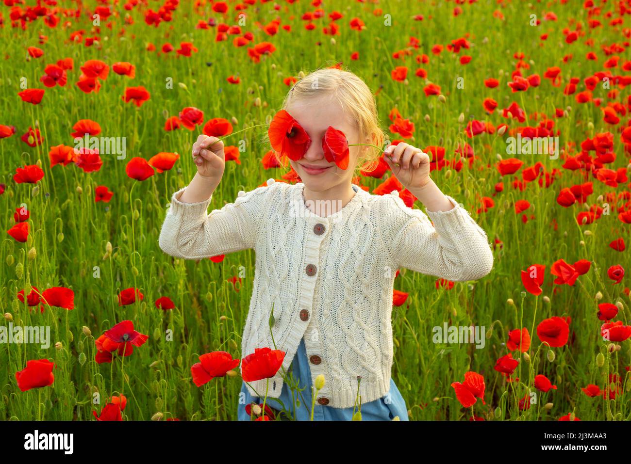 Girl with poppies eyes. Poppies meadow with poppys flowers. Beautiful ...