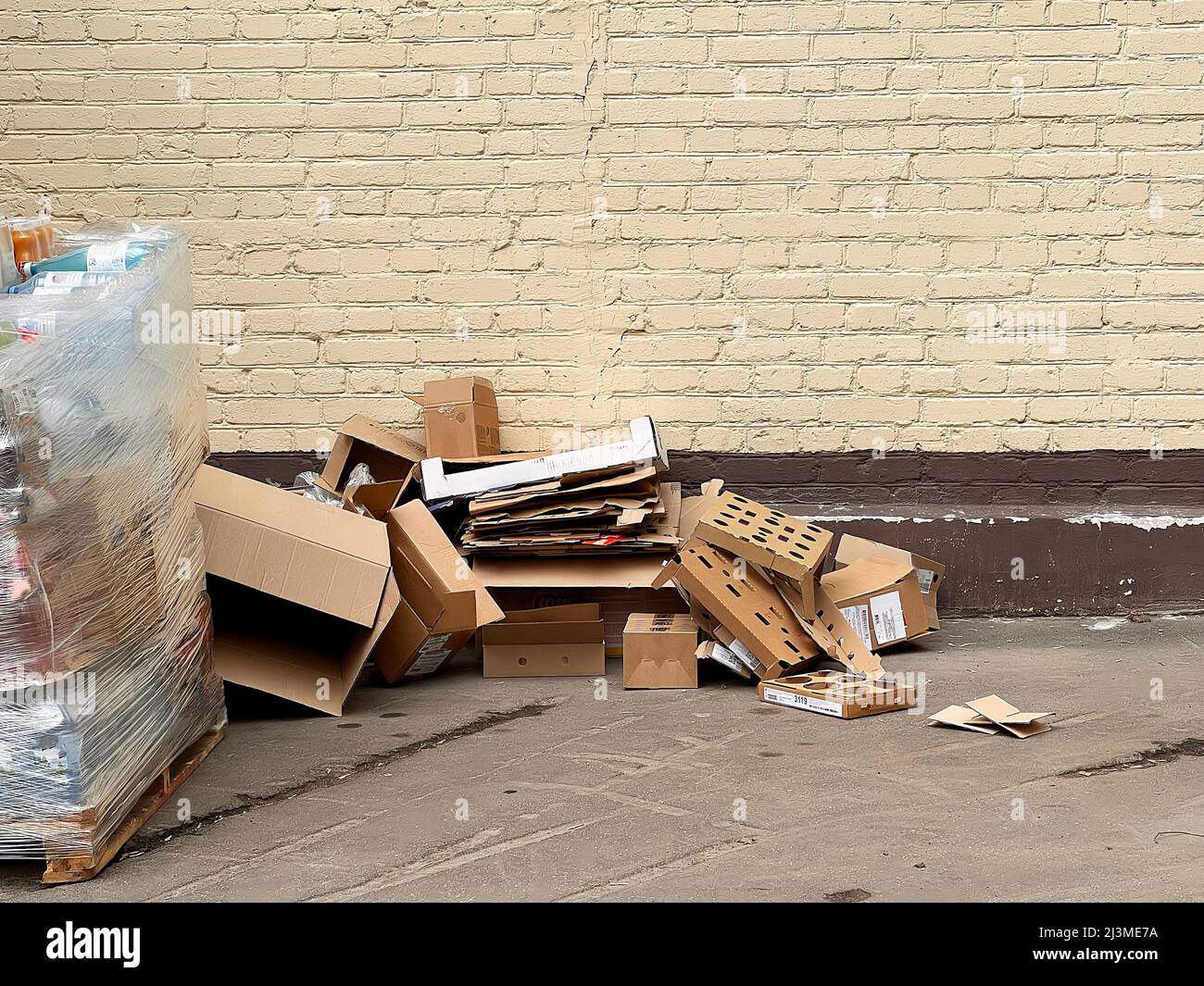 Pile of cardboard boxes appears after unloading goods to store. A lot ...
