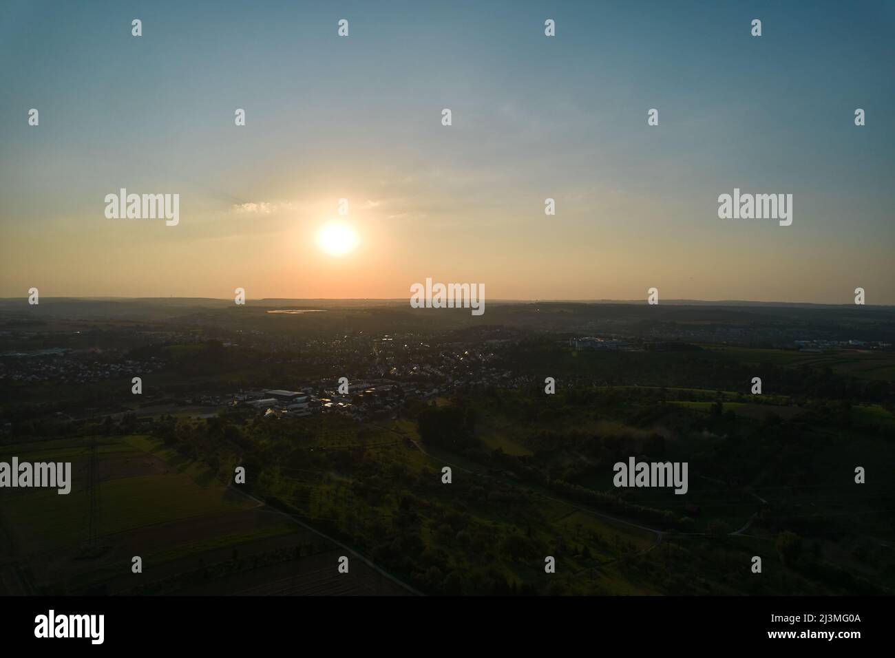 Aerial view of a german city before sunset. Rural area in foreground ...