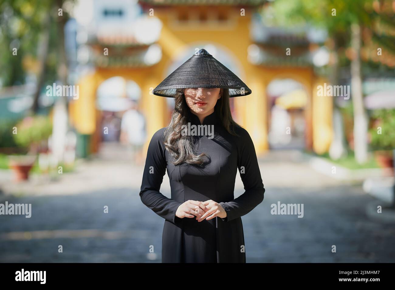 Ho Chi Minh city, Viet Nam: Vietnamese girl going to pagoda in ao dai ...