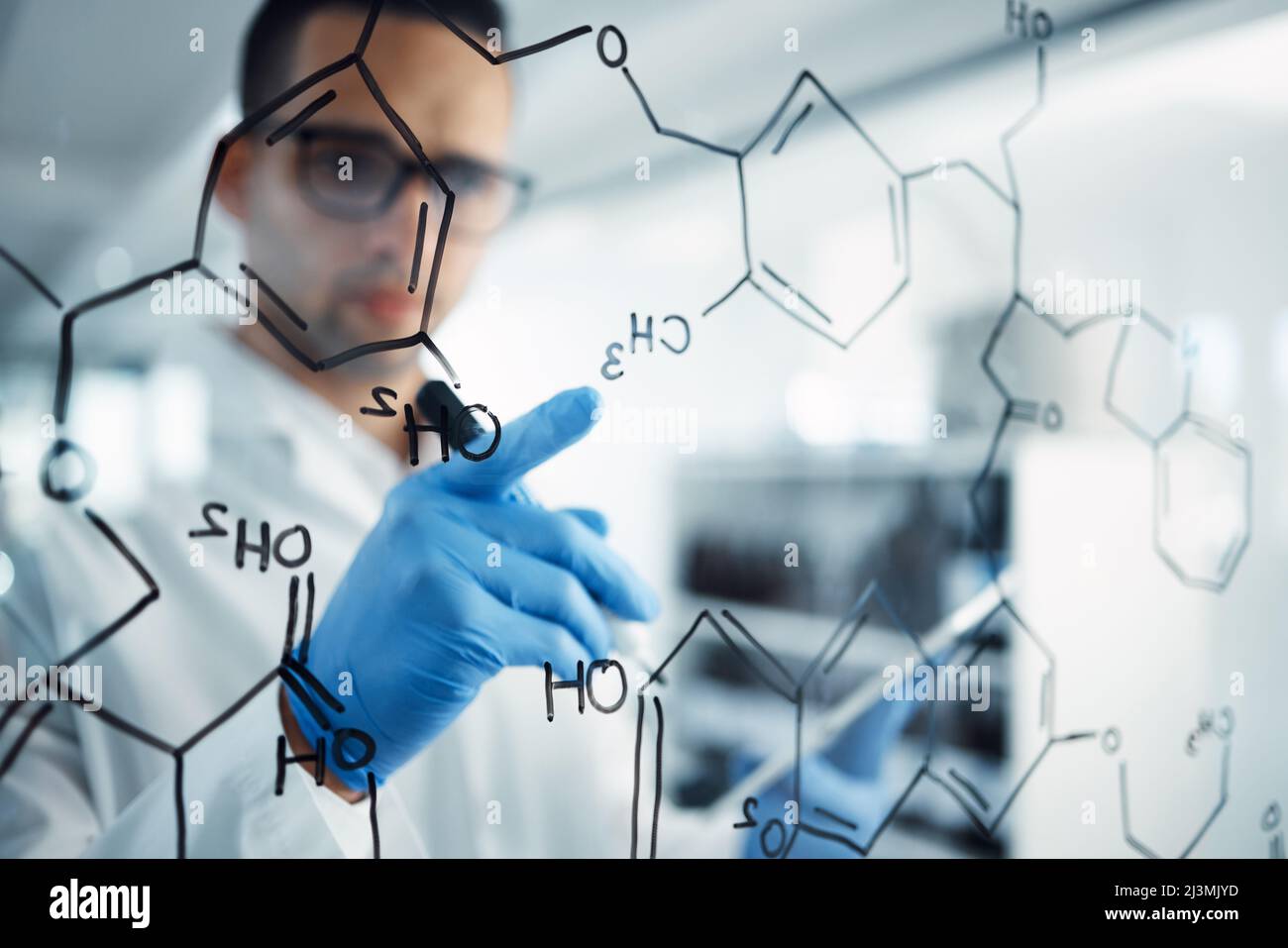 The science man with a plan. Shot of a young scientist solving ...