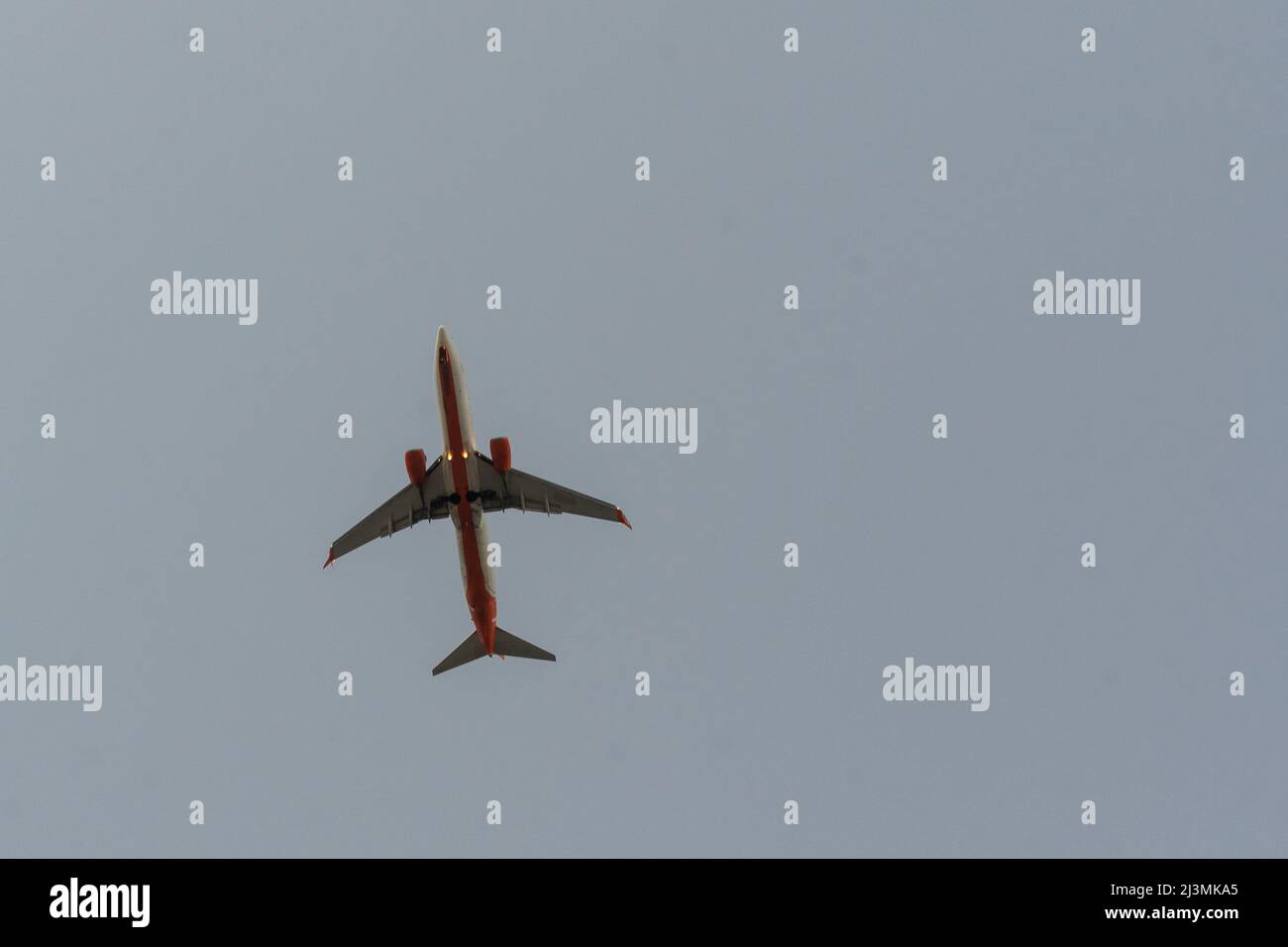 Airplane is flying at blue sky Stock Photo - Alamy